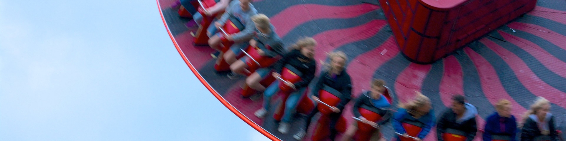 Centrum showing rides as well as a small group of people
