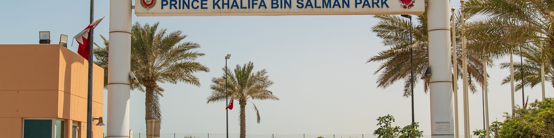 Prince Khalifa Bin Salman Park featuring a coastal town and signage