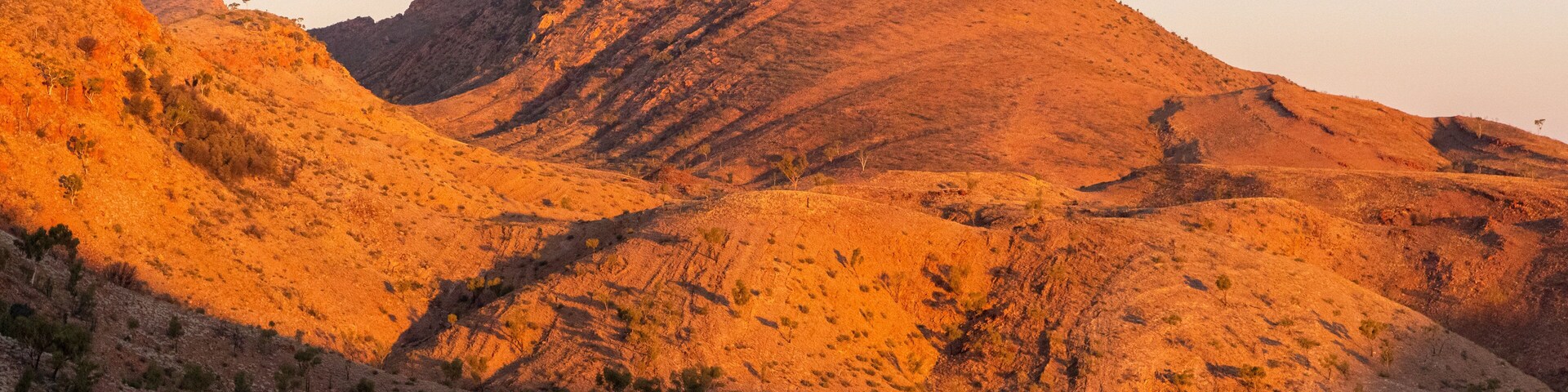 Ormiston Gorge featuring a sunset, desert views and mountains