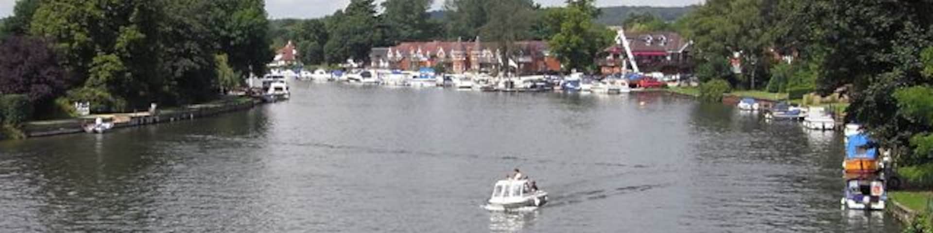 The River Thames, Bourne End The view upstream from the footbridge that accompanies the railway bridge. The footbridge carries a permissive footpath.