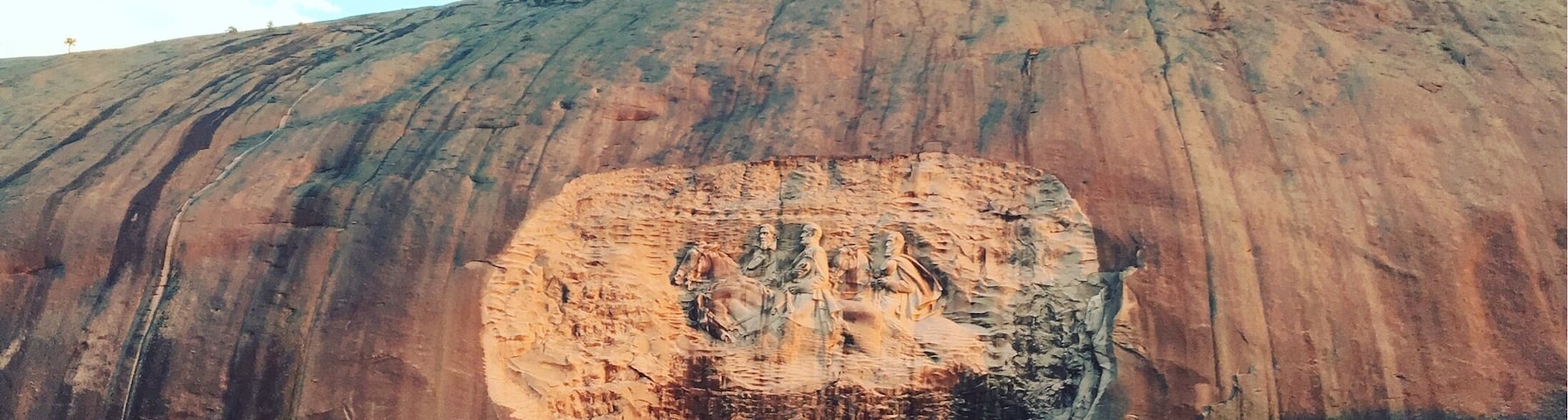 As one watches the sun set over Stone Mountain (controversial Confederate general monument and all), the color of the rock deepens and puts on a beautiful show ❤️ #bruisedpassports