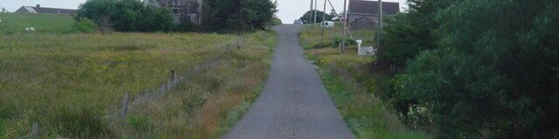 Outend Coll Village Road and Houses. The narrow single track road which loops round the village of Outend Coll.
