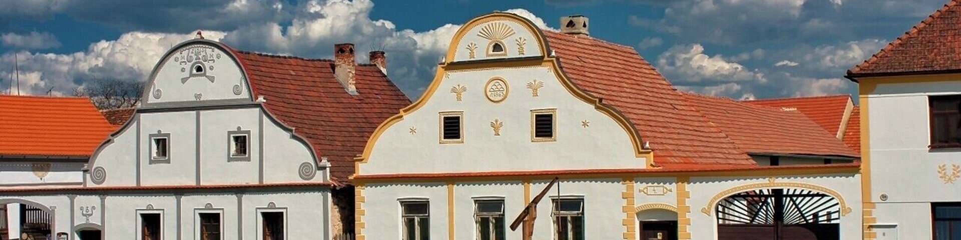 April 2009
Holašovice
Holašovice is a small historic village located in the south of the Czech Republic, 15 kilometres west of České Budějovice. The village was deserted after the Second World War, allowing its medieval plan and vernacular buildings in the South Bohemian Folk or Rural Baroque style to remain intact. It was restored and repopulated from 1990, and it was designated as a UNESCO World Heritage Site in 1998.
Holašovice is a typical Bohemian village for the Hlubocká Blatská area around České Budějovice. It consists of 23 brick farmyards containing 120 buildings, each with their gable end facing a central broad village green, with a fish pond and chapel.
The buildings date from the 18th to 20th century, with most of them built in the second half of the 19th century. They are constructed in the South Bohemian Folk Baroque style.
#UNESCO