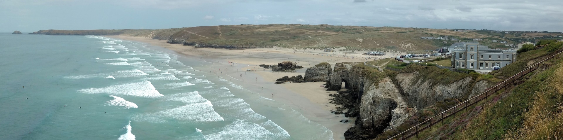Perran Beach, near Perranporth, Cornwall, UK, at mid-tide, looking north. Ligger Point headland in the distance, on the left, Droskyn Castle hotel on the right, the town of Perranporth hidden behind it.