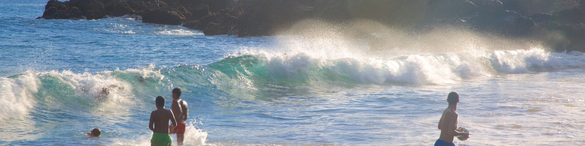 Playa Chica which includes general coastal views, a sunset and waves
