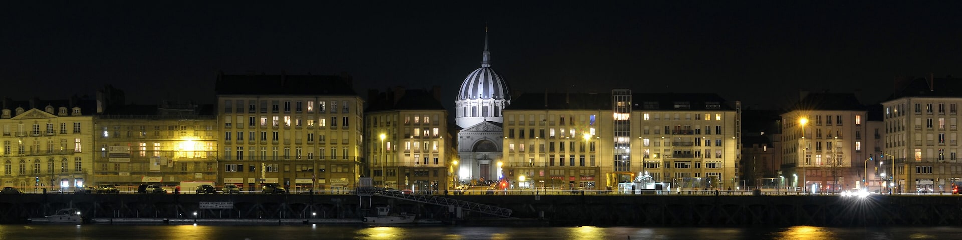 Night view of quai de la Fosse (and its titled buildings) and Notre-Dame de Bon-Port church - Nantes, France