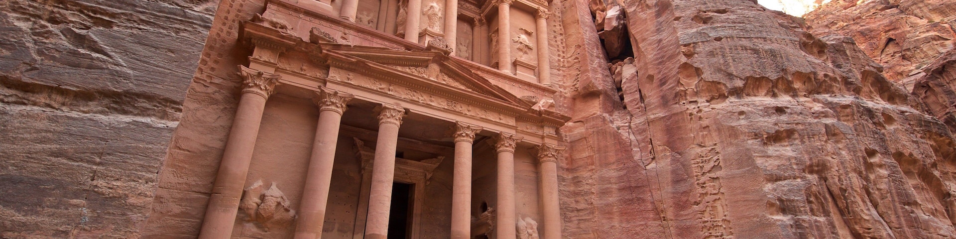 Wadi Musa featuring heritage architecture and a gorge or canyon as well as a small group of people