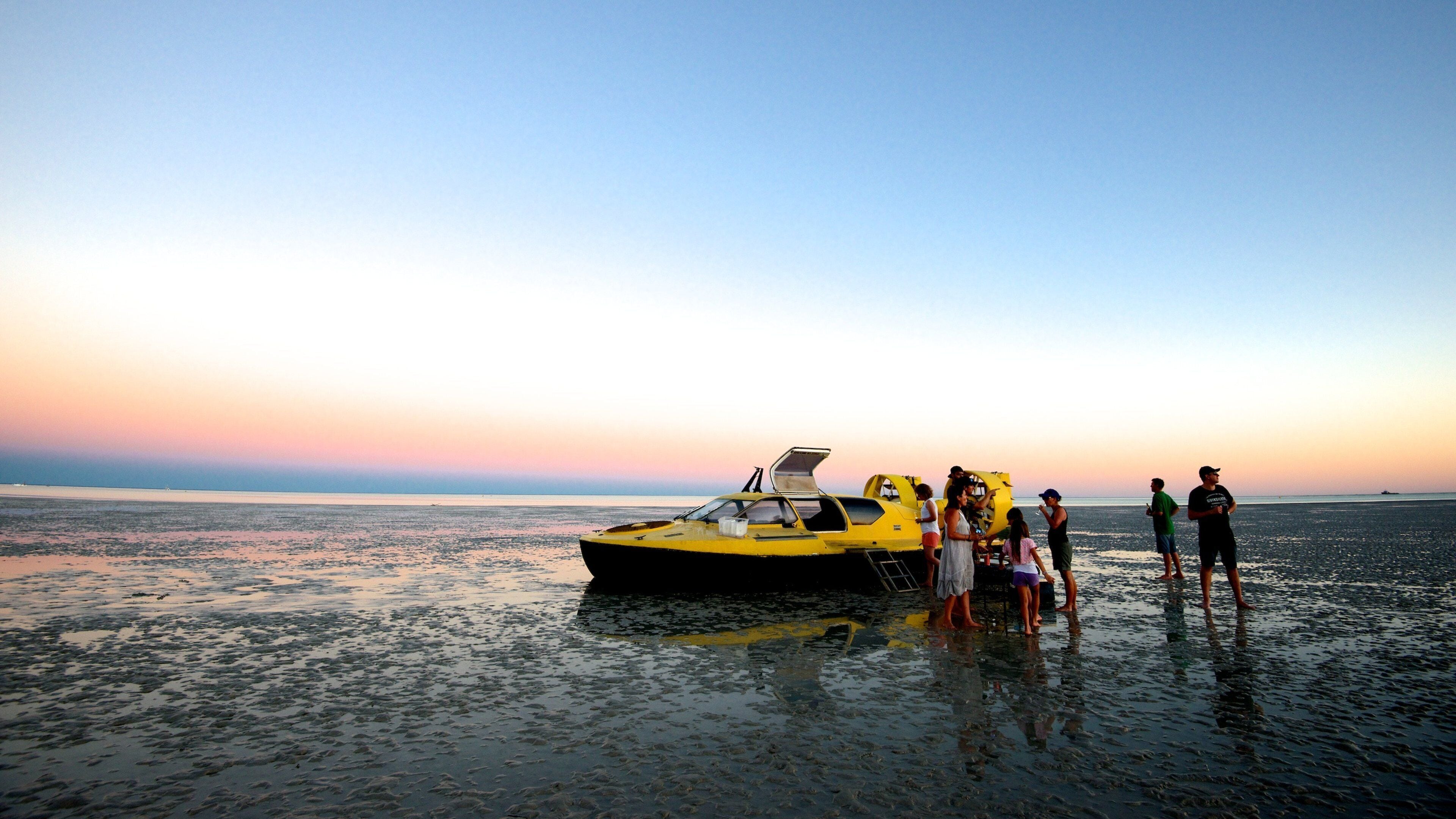 Broome featuring a sunset and general coastal views as well as a small group of people