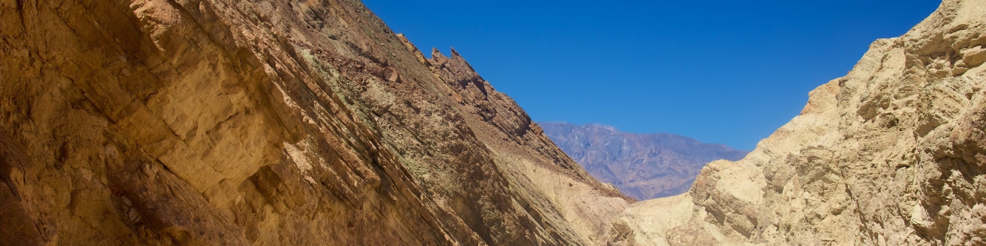 Golden Canyon which includes hiking or walking and a gorge or canyon as well as a small group of people