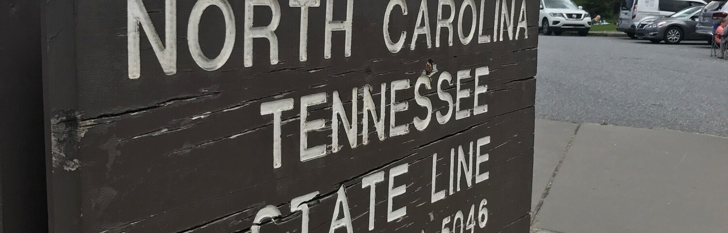 Placa indicando a fronteira entre os estados Carolina do Norte e Tennessee, com altitude de 1538 metros, no Parque Nacional das Montanhas Fumegantes.
