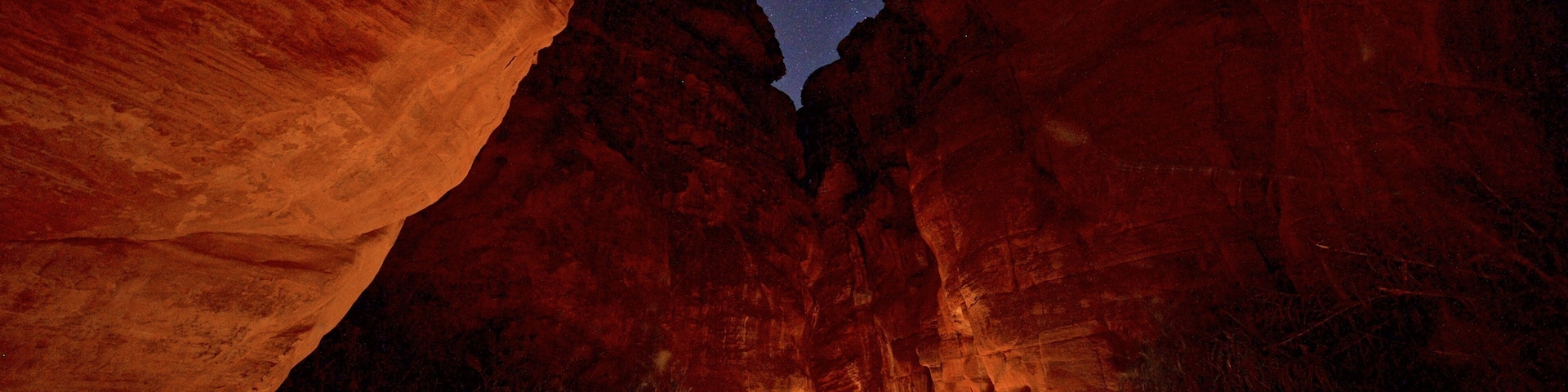 al-Siq showing a gorge or canyon and night scenes