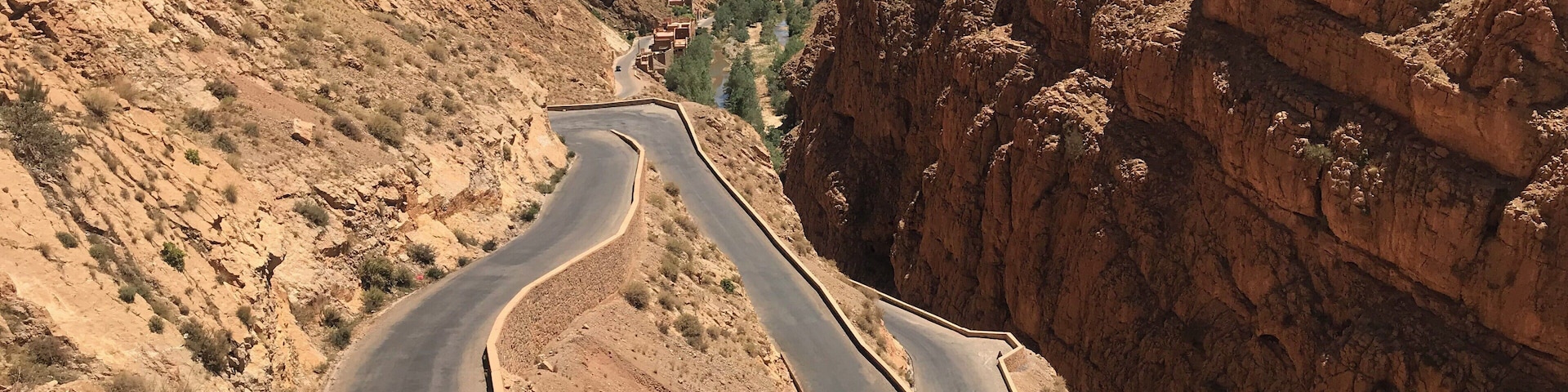 Road leading down into Dades Gorge where an oasis of plants, a Berber village and water live between beautiful sandstone mountains. #dadesgorge #morocco #africa #berber #earthbound #travel #slowtravel #travelmorocco #mountains #sandstonemountains #moroccanmountains #roadtrip #ilovemorocco #flashpackingbarbie