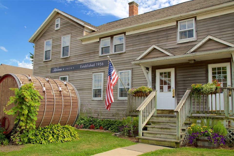 A building with a sign reading "Adlerman Winery Established 1956" and an American flag.