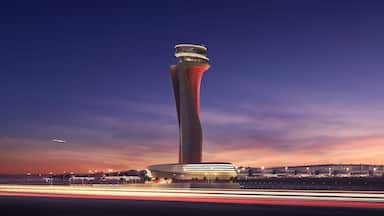 Um aeroporto moderno com uma torre e terminal distintos.