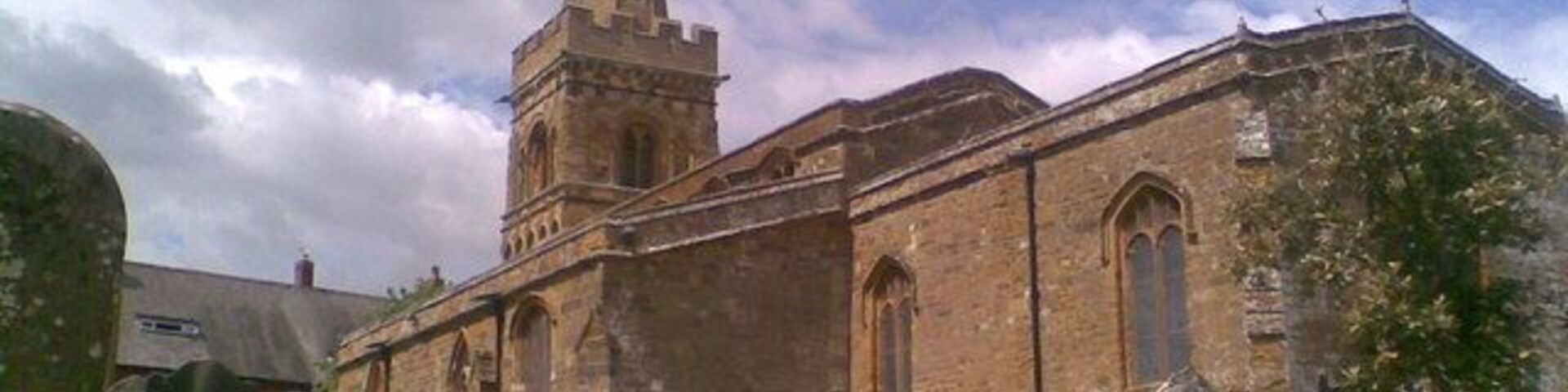 Uma igreja histórica com uma torre alta e janelas em arco.