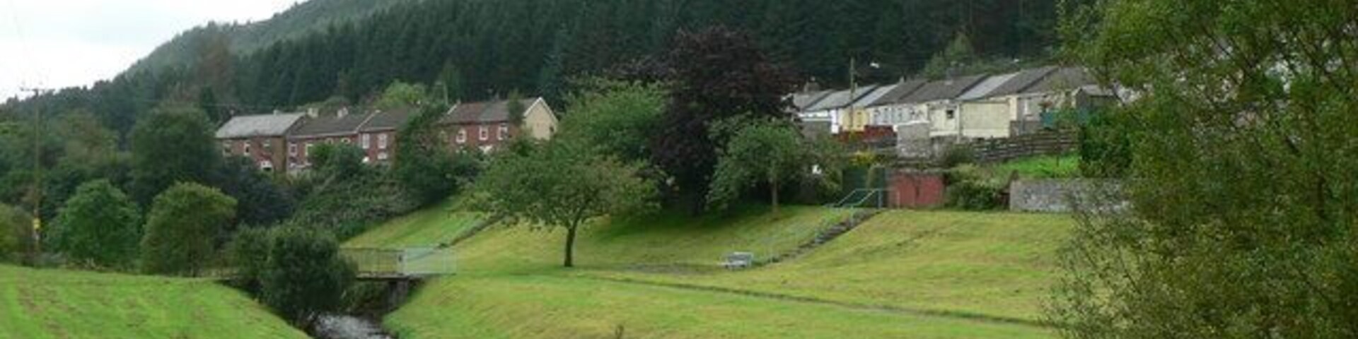 River and forestry at Nant-y-moel. Houses in the picture are opposite the main concentration of buildings here and on the opposite side of Cwm Ogwr.