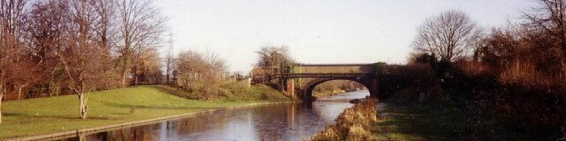 Grand Union Canal, Slough arm. A view eastwards along a boggy towpath towards the bridge carrying Middlegreen Road over the canal.