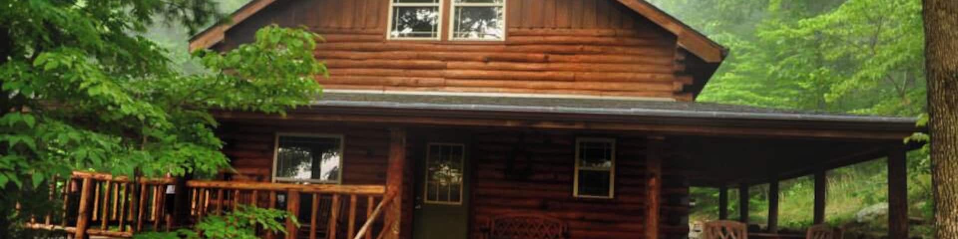 Nestled in the hills of Arkansas, within minutes of the Buffalo National River, is a hidden gem of a cabin. Boasting a wrap-around porch with hand peeled cedar, this cabin took 2 years to be built. A steady spring can be heard trickling into the pond below. And on summer nights the wild croaking can be heard from the pond's residents.
15 minutes from this cabin is Boxley Valley, home of the famous Arkansas Elk Herd. Horseback riding is also available on a 180 acre ranch. Don't forget to sign the guestbook if you choose to stay, guests from near and far have written about their travels and stay.