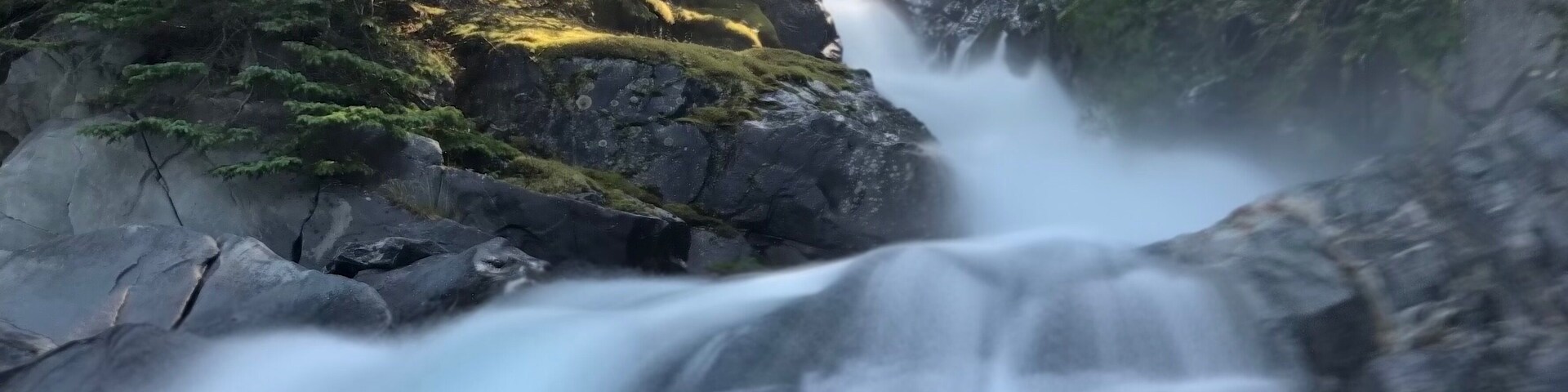 Adventure Bridal Veil Falls near Haines Alaska as seen from a shuttle boat transporting us to a hike and canoe ride to see Davidson Glacier near Haines Alaska.
