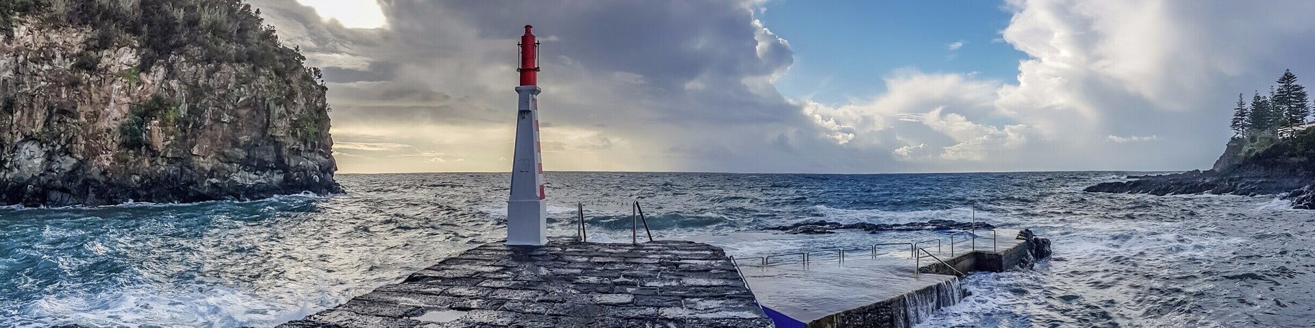 From the port of Caloura between heavy showers and sunshine. Not the day to take a swim.