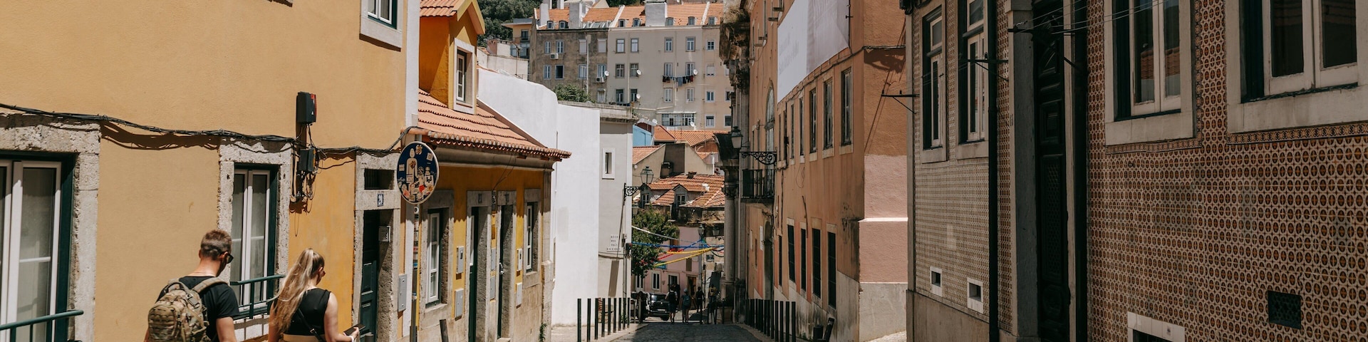 Mouraria featuring street scenes as well as a couple