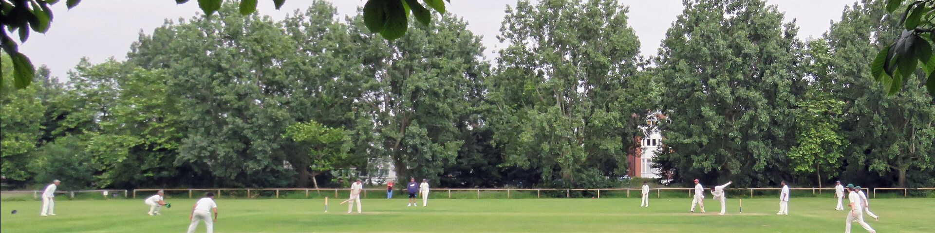 A public Sunday cricket match between Woodford Green CC Sunday 'B' XI and Hackney Marshes CC 1st XI (Hackney batting) at Woodford Green, Woodford, East London, England, in June 2018. Woodford Green CC fields three Saturday teams in the Shepherd Neame Essex League, a Twenty20 team, a Midweek team, two Sunday friendly teams, and seven junior section teams. Camera: Canon PowerShot SX60 HS Software: File lens-corrected, optimized, perhaps cropped, with DxO PhotoLab, and likely further optimized with Adobe Photoshop CS2.