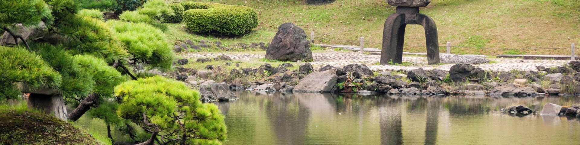 Stone lantern at a pond in Shibarikyū Park in Tokyo