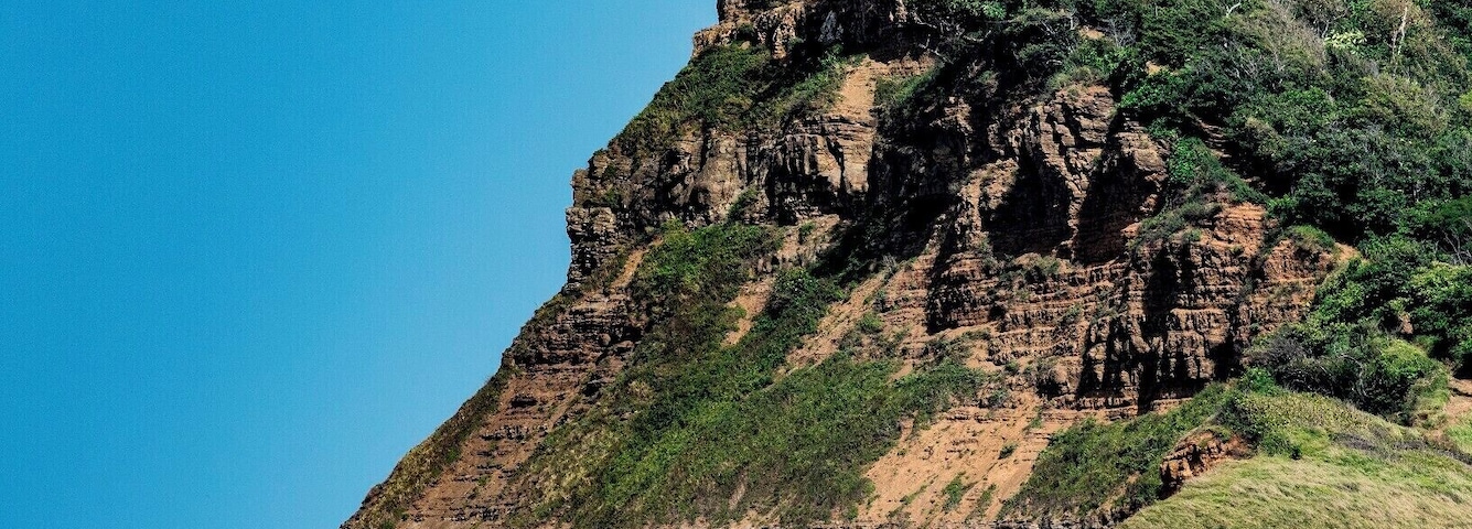 Lush green headland and inviting ocean on this beautiful beach. #BeachBound #beachtips