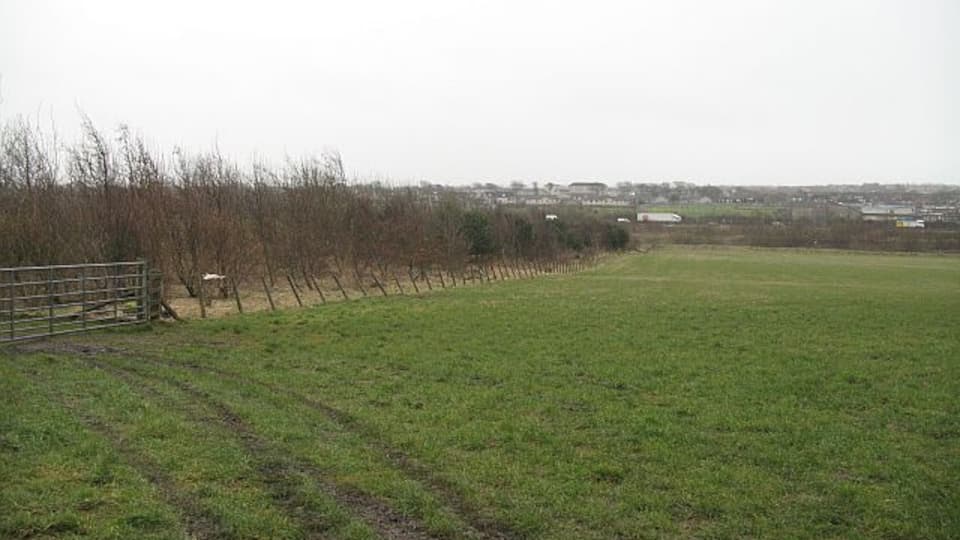 Reclaimed land , Whitburn View over flat fields on what was once mine workings towards the traffic on the M8.