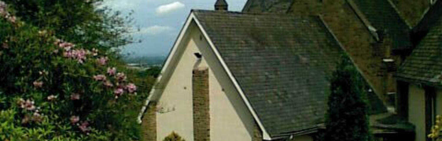 Garden path at Shrigley Hall, Cheshire Shrigley Hall, once a private residence, and later a Salesian missionary college for Catholic boys, became a country hotel in 1989. The building to the right was originally a church. It was built in 1926 by the monks for their own use. The steps descend from the car park to the spa, and beyond to front of the hotel. In the distance, through clouds, the Cheshire plain can be seen.