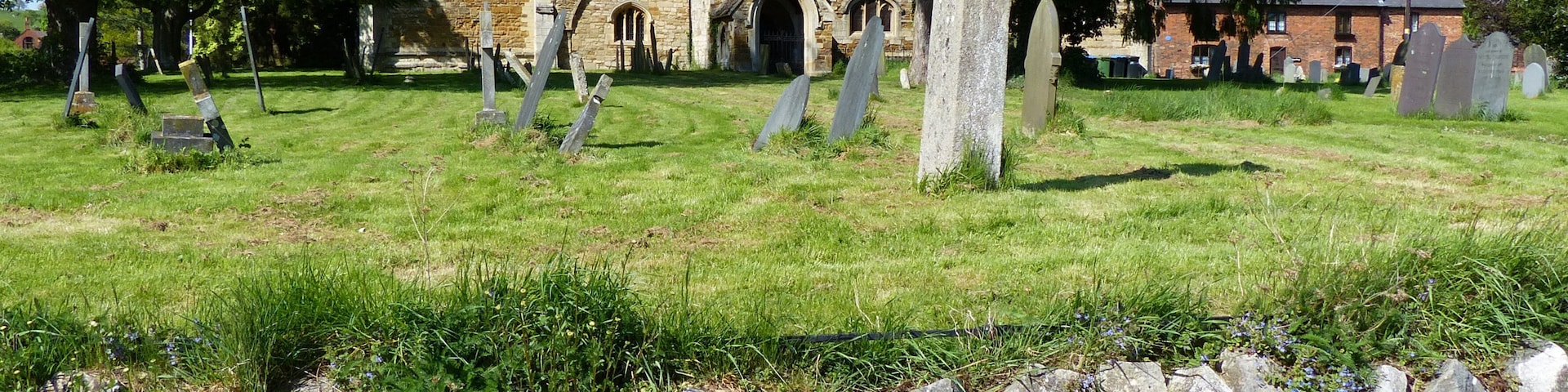 Gravestones in All Saints' parish churchyard, Lubenham, Leiecstershire, seen from the south
