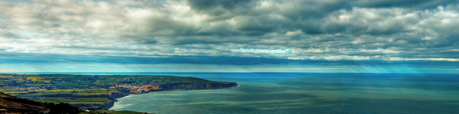 Robin Hood's Bay and Boggle Hole from above Ravenscar, North Yorkshire. Six shots stitched in portrait format at 50mm. Same aperture throughout. Light HDR applied and highlighting to the town. Website | Facebook Fan Page | Twitter