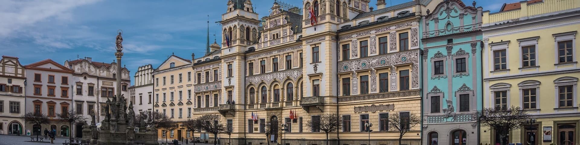 Pardubice became a town sometime around 1340. Back then it was owned by the Lords of Pardubice, the most prominent figure of the line being Arnošt of Pardubice, the first Archbishop of Prague, advisor and friend to Emperor Charles IV, a distinguished European personality of that time. Buildings on the square and adjacent streets bear the oldest traces of early gothic architecture. The neo-renaissance city hall of Pardubice is the main focal point.
Arnošt of Pardubice, the Velká Pardubická Steeplechase, the Golden Helmet, gingerbread – this is just a brief list of what Pardubice is famous for in the minds of people in the Czech Republic and the entire world.
However, if you are not an enthusiastic historian, sports fan or culinary gourmand, you can catch up by reading the following crash course on the city. Pardubice lies on the point where the Labe and Chrudimka rivers meet and dates back to more than 700 years.
The emblem, which Pardubice has been using as its symbol since the 12th century, is created from a silver horse on a red background. The city experienced its greatest flourishing during the time, when the estate belonged to the noble family the Pernštejns, who gave the historical centre of Pardubice’s its appearance. They say that Pardubice is a city of sports, horses and gingerbread, and it can also be considered the city of transportation. The historically first railway route from Olomouc to Prague leads through here, an international airport is situated here, you can reach the city by car and perhaps even by boat soon. So, now you know how to get to Pardubice.
#europe #czech #czechrepublic #city #cityscape #gothic #architecture #travel #history #instone #details