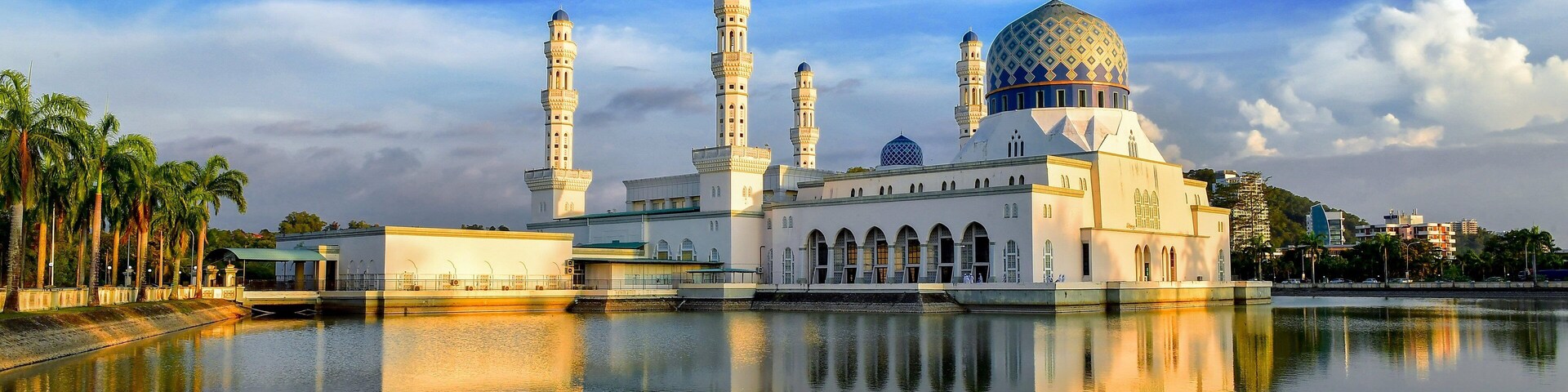 Kota Kinabalu which includes a lake or waterhole, heritage architecture and a sunset