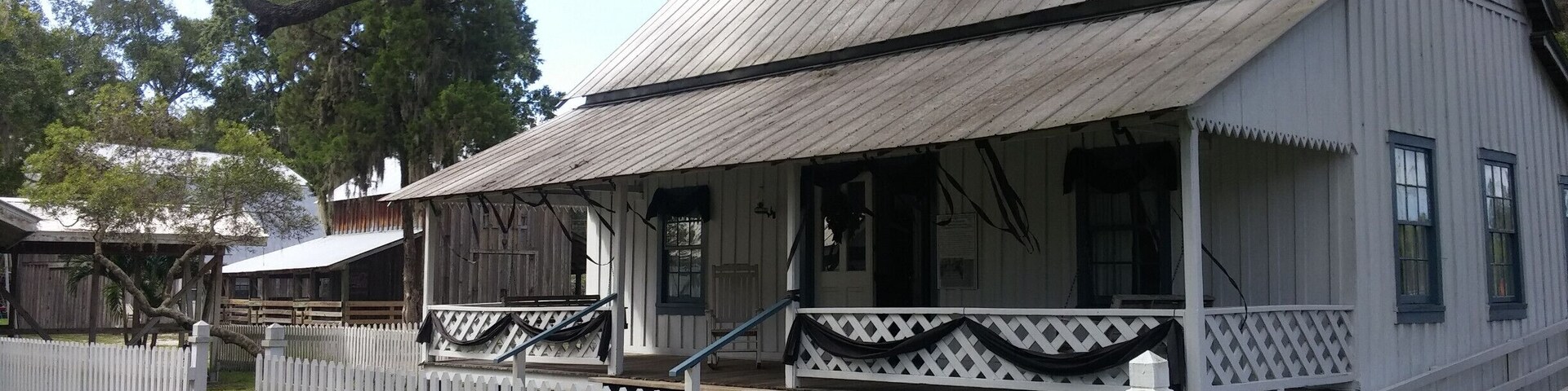 The settler's house was built in 1912 and is furnished with period artifacts. Currently, the house is setup with an exhibit about the customs and cultures of showing the bodies of deceased family members.
The historical park is free and boasts the 1860 Courthouse, the 1887 Church, the One Room Schoolhouse, the Old Settler’s House, the Potter Barn, the Sugar Cane Mill and Smokehouse, the Wiggins Store, a blacksmith shop, a 1913 Baldwin Steam locomotive, the Fogarty Boatworks and a Cowhunter Bunkhouse.