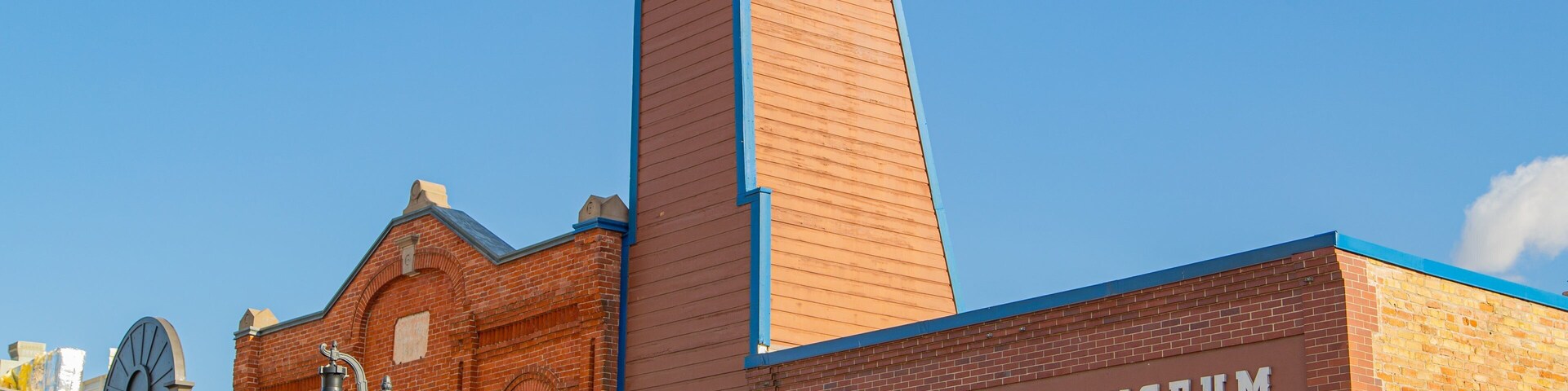 A brick building with a blue awning labeled "Park City Museum."