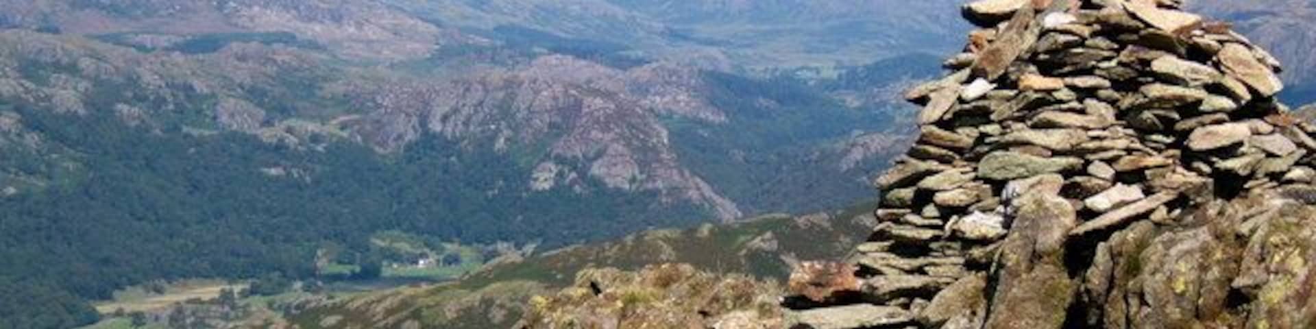 Summit cairn of Stickle Pike Looking north to Esk Pike, Bowfell and Crinkle Crags.