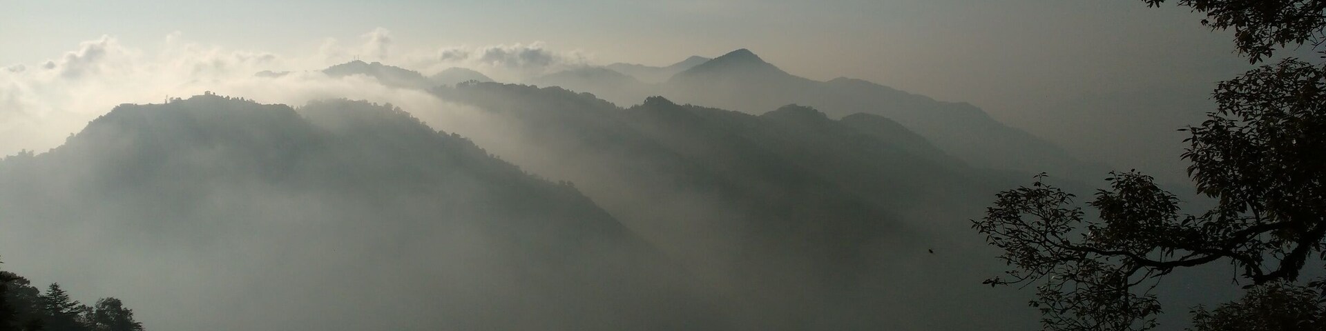 The view of the rolling hills from Landour. It's surreal, here! 
I love to get some black coffee from Cafe Ivy at Char Dukkan while enjoying the view from the café, and then I head off on a walk along the "chakkar" to get to this spot where I relish on some peace, quiet and happiness. It might be the same routine for me when it comes to this route, but this spot and this view is always calling out to me. And, I just cave!