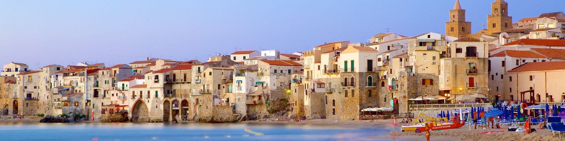 Cefalù mostrando uma praia e uma cidade litorânea
