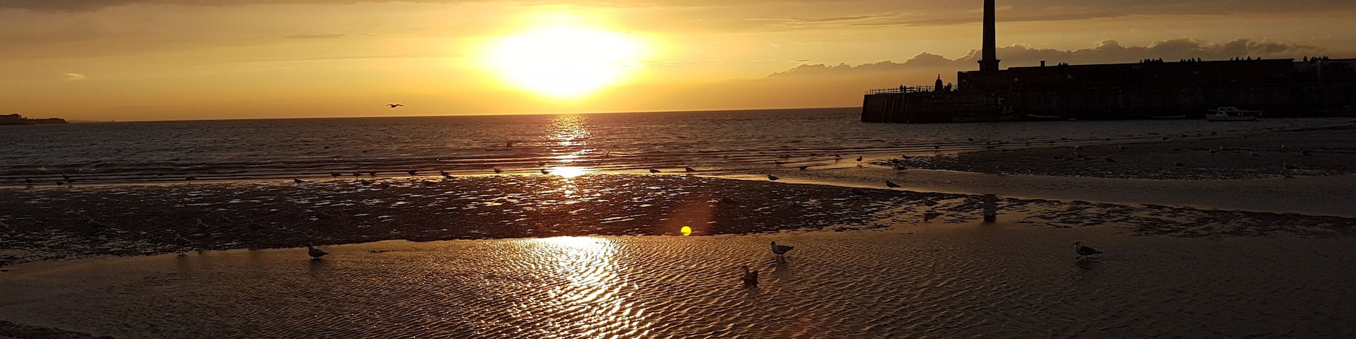 Sunset over Margate Harbour at low tide