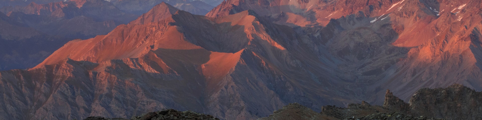 Late afternoon shot taken at the Bivacco Gratton when the sun had already set behind the Grivola. Right in front, on the other side of the Valle di Cogne, the Vallone di Arpisson, the Passo dei Tre Cappuccini and the Emilius. In the far distance, on Valle d'Aosta's other orographic side, the Grand Combin and the Cervino (I don't know the name of the beautiful peak on the left, which I guess must be famous. Suggestions are welcome). Two versions of the same shot (one exposed for the foreground and the other for the background) combined together with Photoshop Elements.
