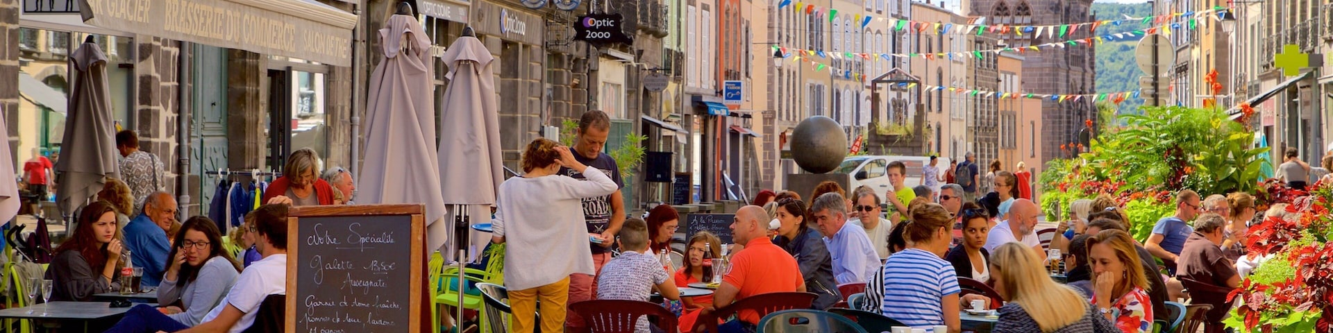 Riom which includes a city, outdoor eating and signage