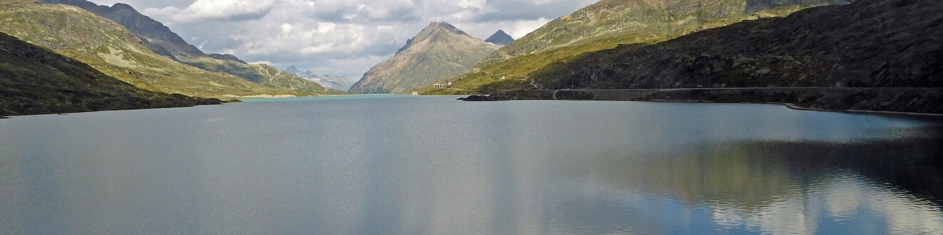 Lago Bianco (literally "White Lake") is a reservoir at the Bernina Pass, Switzerland. Its elevation is 2,234 m (7,329 ft). The reservoir was formed by the two dams Scala and Arlas on the site of two natural lakes (Lago Bianco and Lago della Scala). The narrow-gauge rail track provides the highest regularly scheduled train service in Europe at this site.