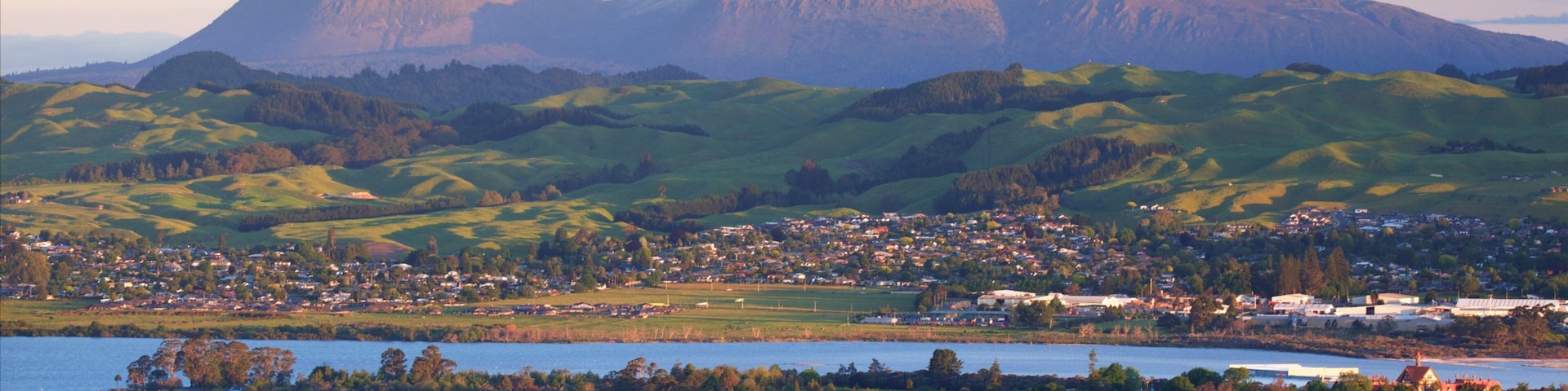 Kawaha Point showing mountains, a sunset and a river or creek