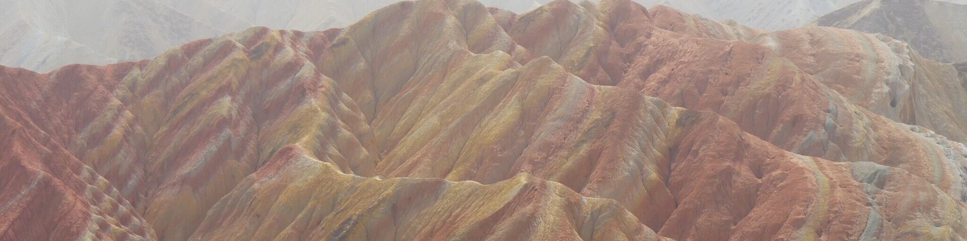 Zhangye National Geopark, the "Rainbow" or "Colorful" Mountains. About 30 minutes west of the city of Zhangye in the Gansu province of China. Buses from two park tourist centers ferry you to 4-6 stops within the park where you can climb up to various viewing platforms and walkways.
#Red