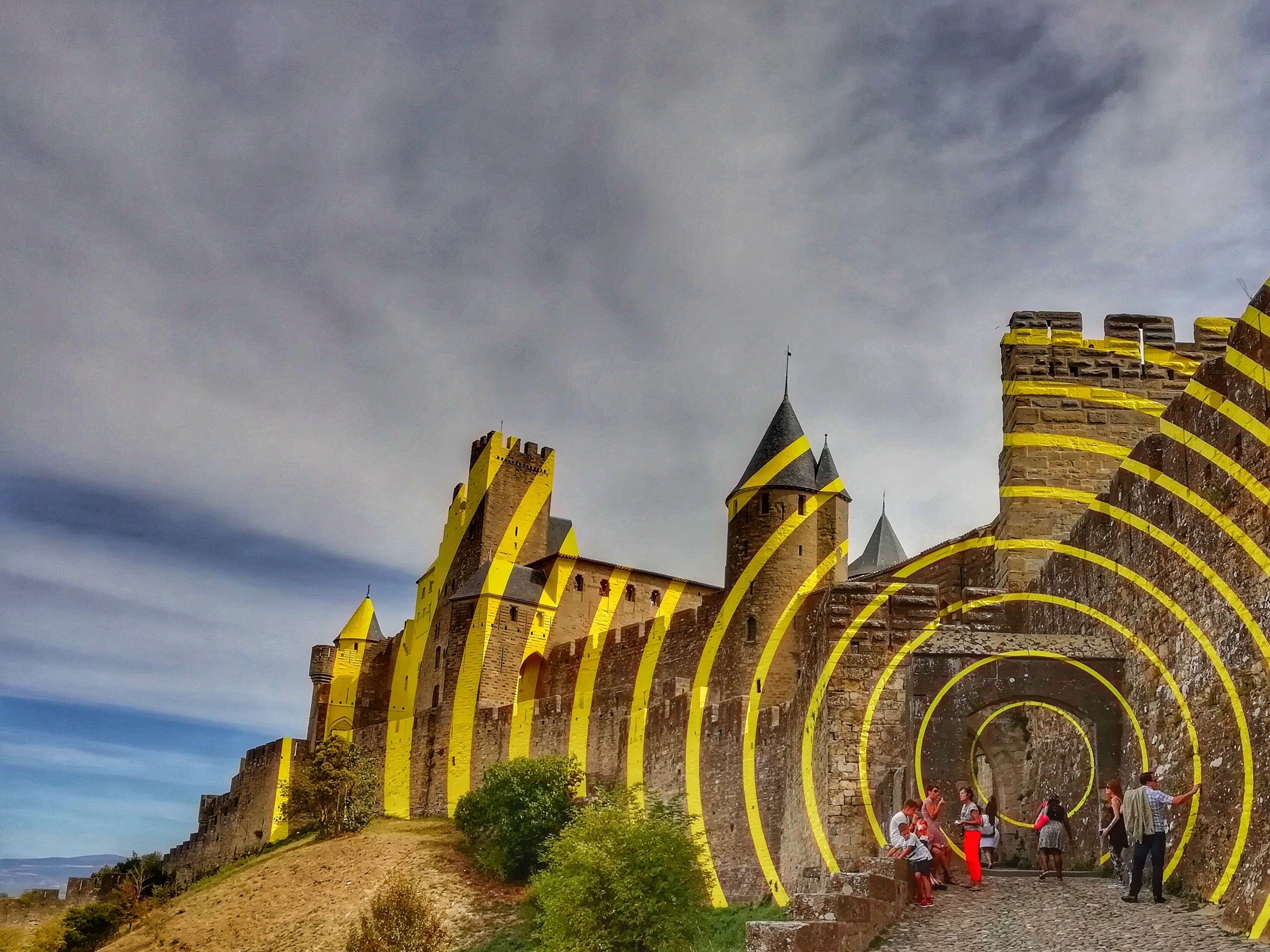 This is one of the entryways to the medieval city at Carcassonne. When I visited, it had this art installation - those circles are physically there! 
