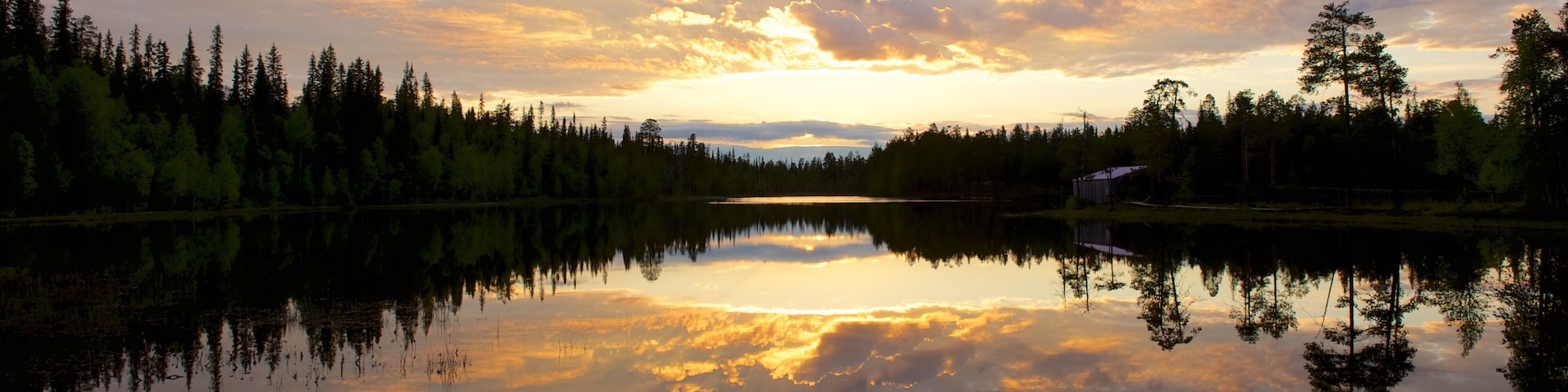 Luosto which includes a lake or waterhole and a sunset
