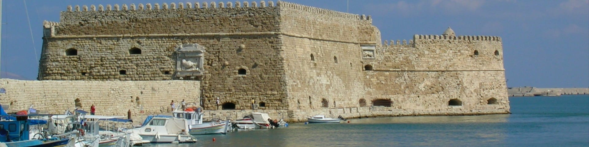 Heraklion featuring chateau or palace, a marina and heritage architecture