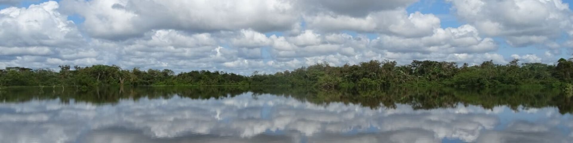 A view of the clouds and sky reflecting off the waters of the Río Frío near the Nicaraguan border.
Flip the photo over and it looks almost the same!
We booked a boat tour though anywherecostarica.com along the Río Frío in the Caño Negro wildlife area.
Absolutely worth it! They pick you up right at your hotel, take you to the boat, spend a couple hours on the river spotting wildlife, provide lunch and drop you back off at your hotel.