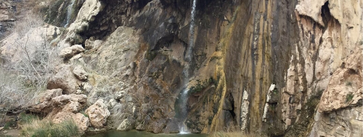 Sitting Bull Falls view from the observation deck at the base. Getting down to the rocks below to take a dip requires managing some rough steps and slippery surfaces.